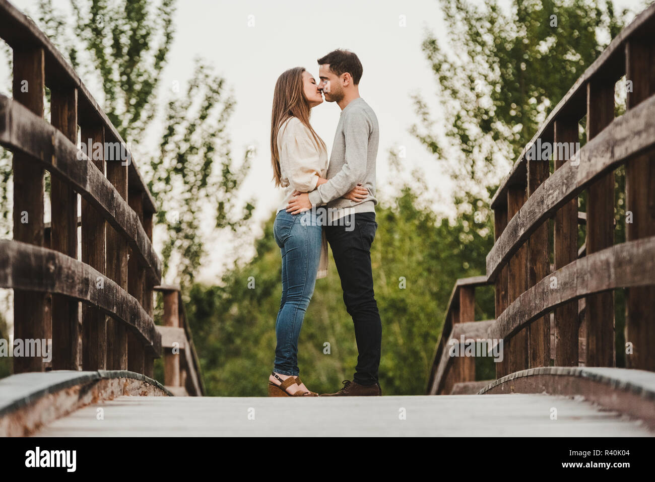 Couple in love hugging each other with their hands Stock Photo - Alamy