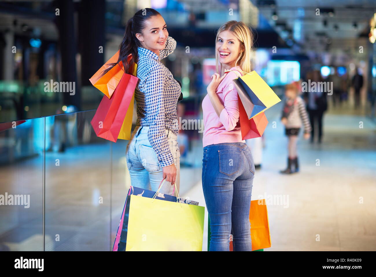 happy young girls in shopping mall Stock Photo - Alamy