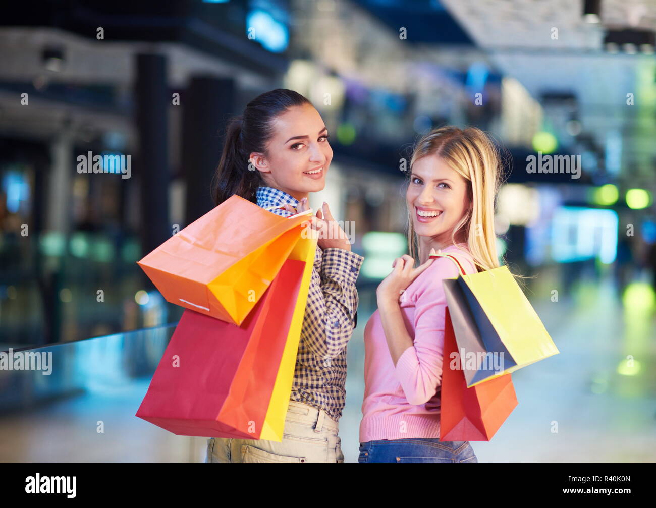 happy young girls in shopping mall Stock Photo - Alamy