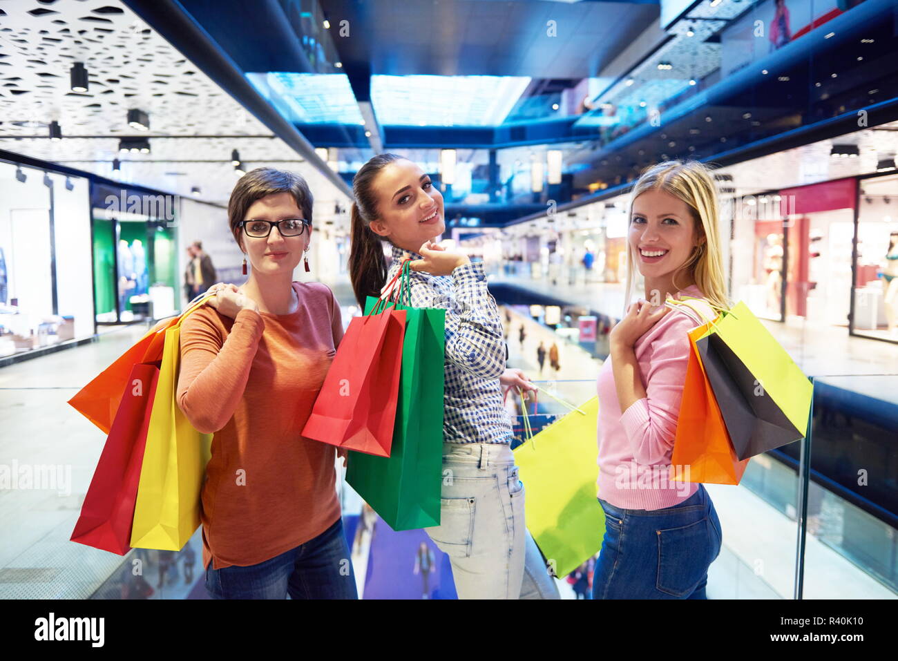 happy young girls in shopping mall Stock Photo - Alamy