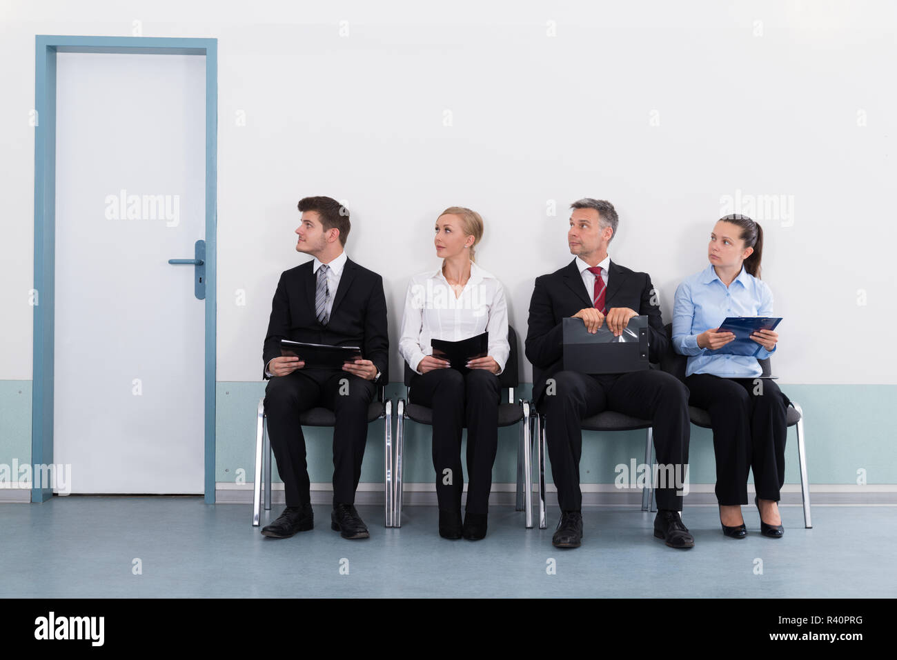 Businesspeople Sitting On Chair For Giving Interview Stock Photo - Alamy