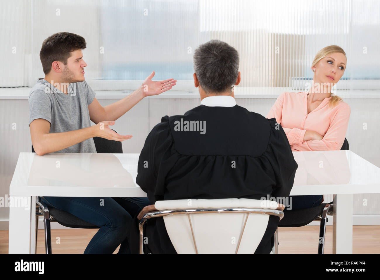 Judge In Front Of A Couple Having Conflict Stock Photo - Alamy