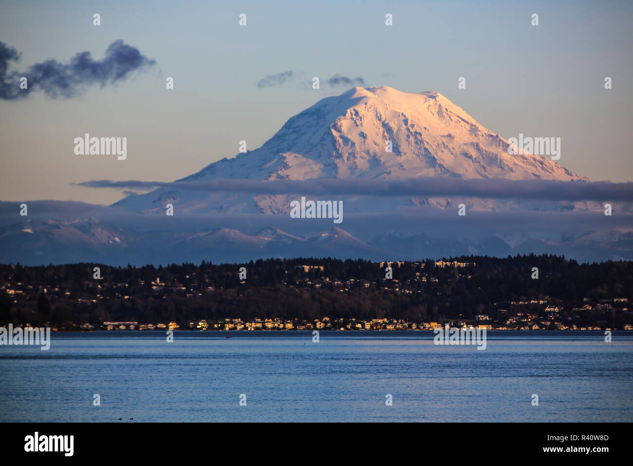 Fox Island, Washington State. Snowy Mount Rainier towers over land and ...