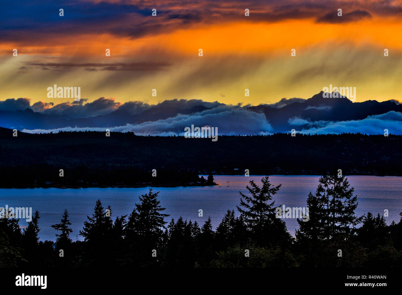 Bremerton, Washington State. Sunset and fog over the Olympic Mountains ...