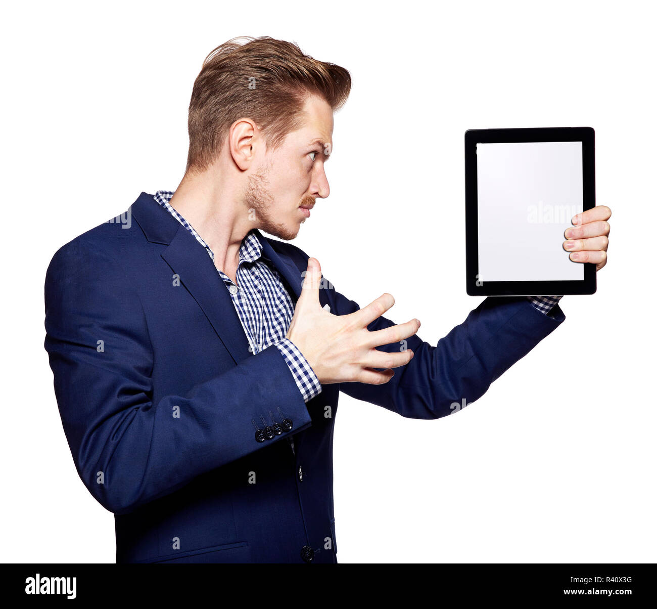 Angry young man and tablet PC Stock Photo - Alamy