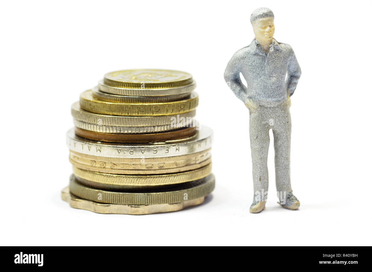 Miniature people with coins Stock Photo - Alamy