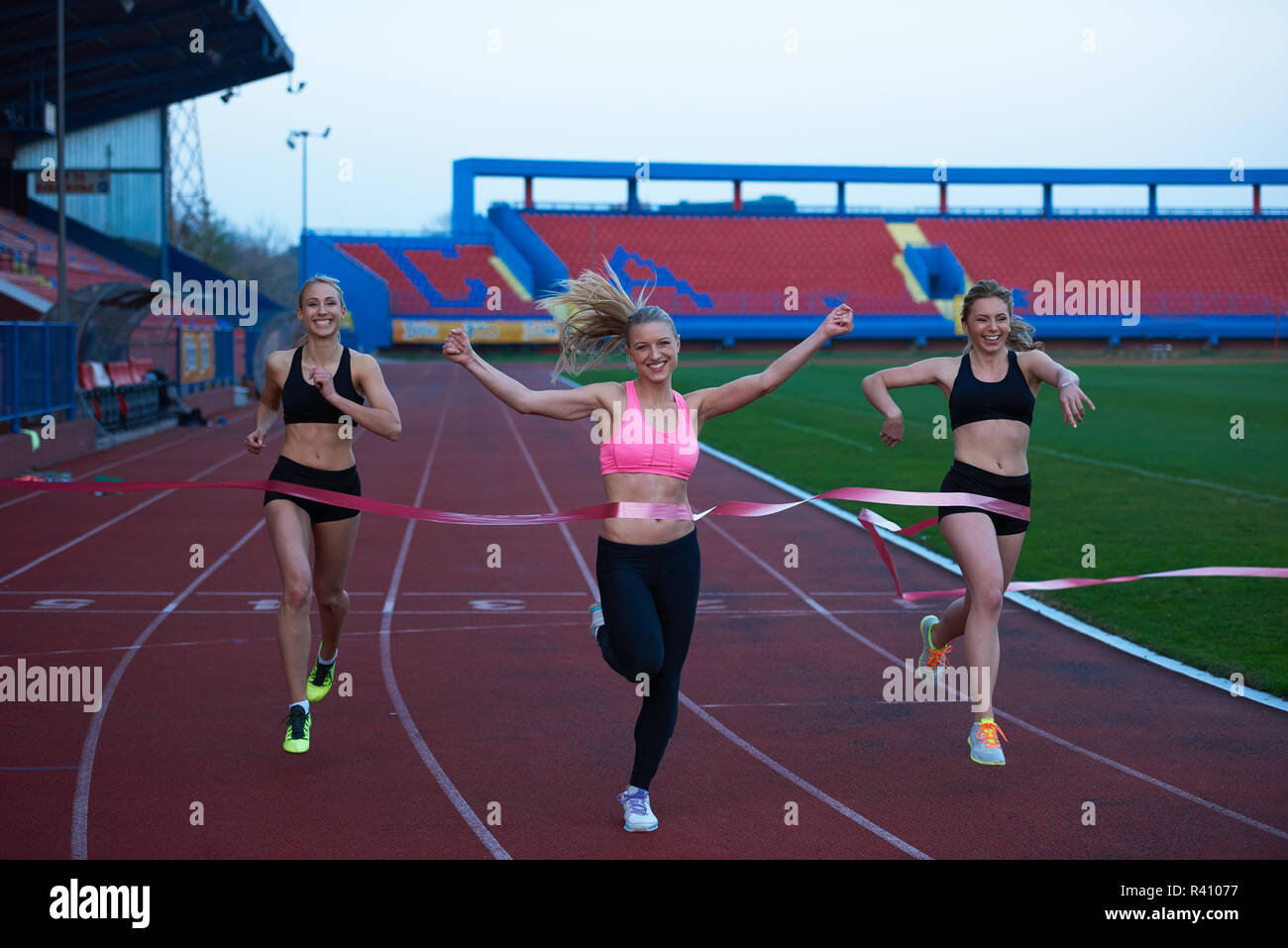 Female Runners Finishing Race Together Stock Photo - Alamy