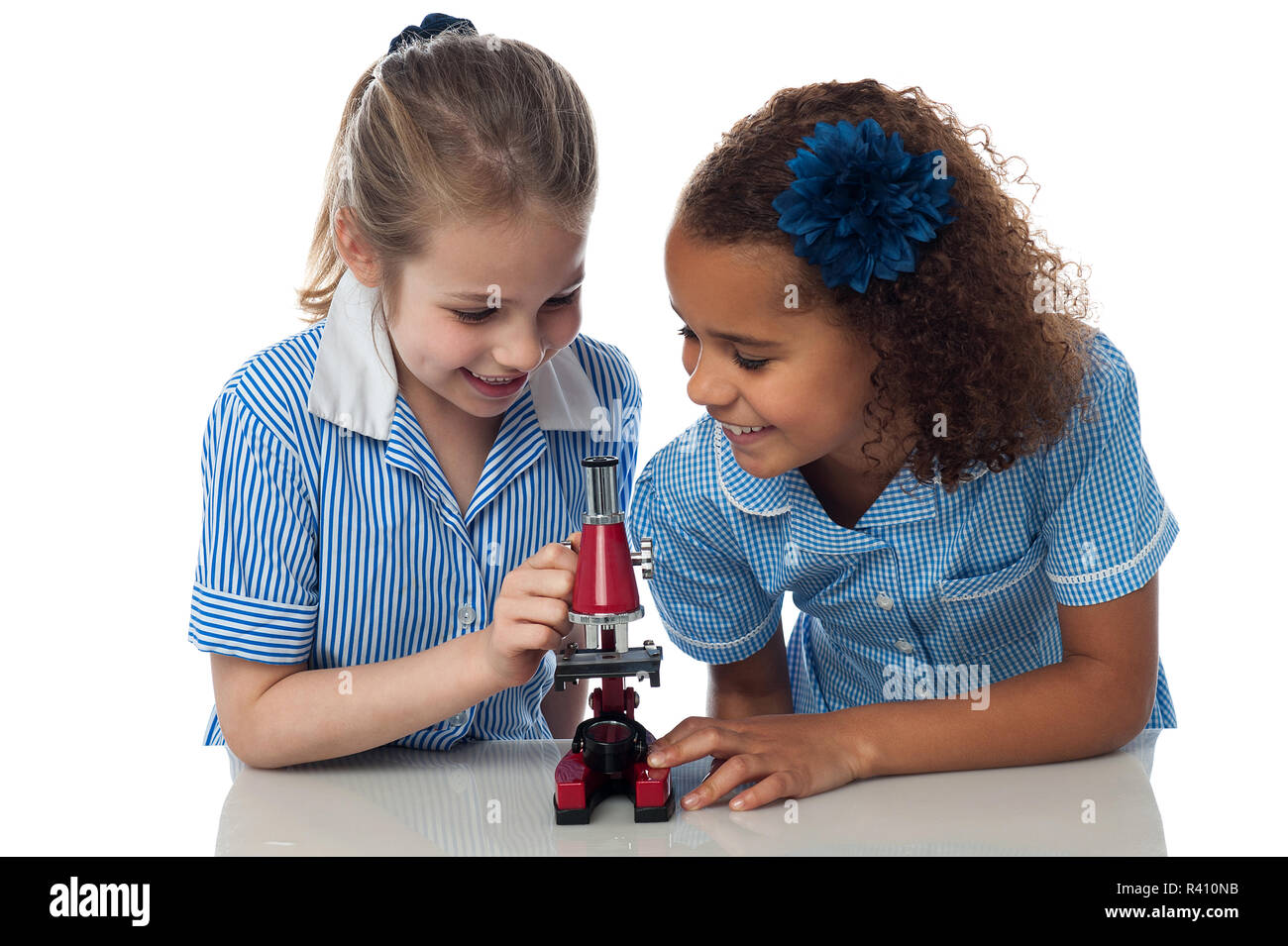 Schoolgirls learning with microscope Stock Photo - Alamy