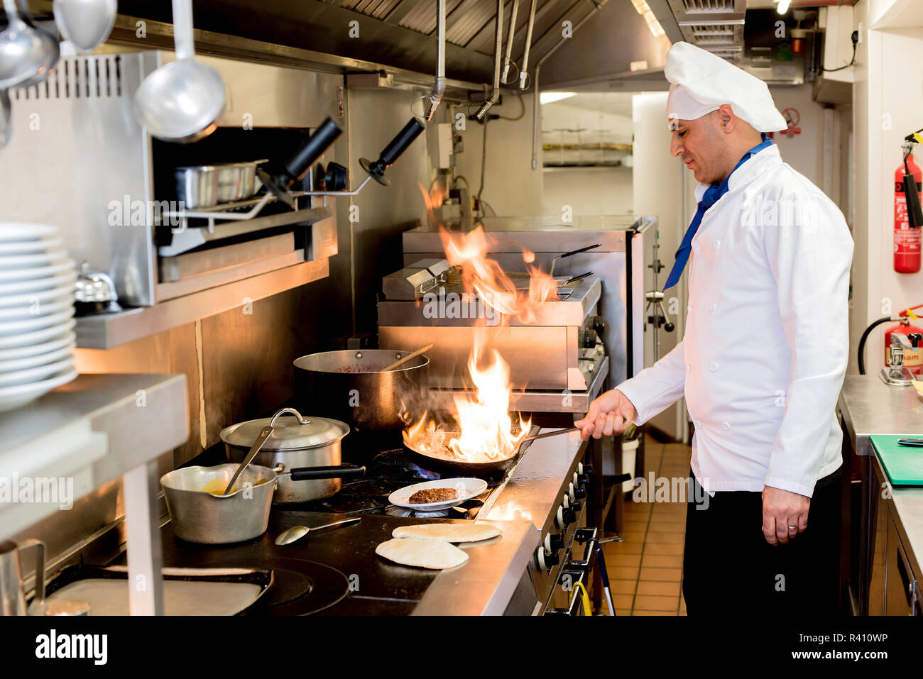 Chef with burning flames on kitchen Stock Photo - Alamy