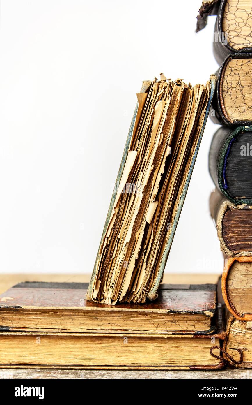 Old books on a wooden shelf on a white background. Study of old books ...