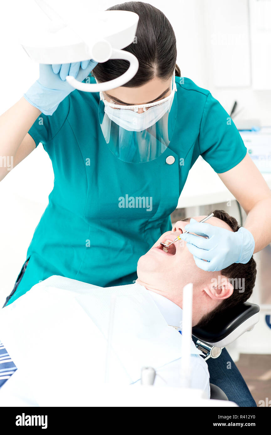 Female dentist doing teeth checkup Stock Photo - Alamy