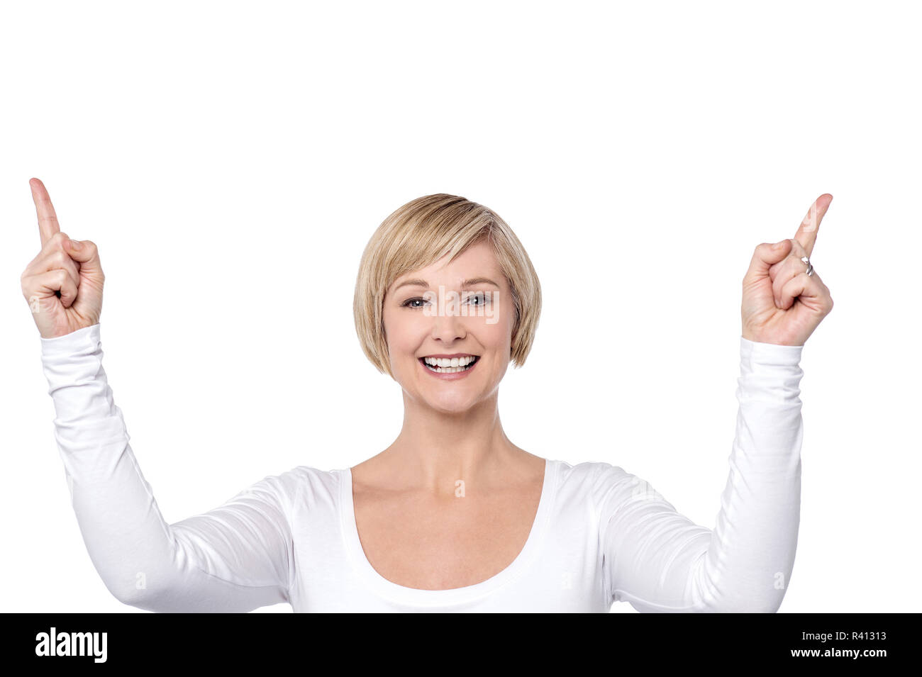 Cheerful lady pointing up Stock Photo - Alamy