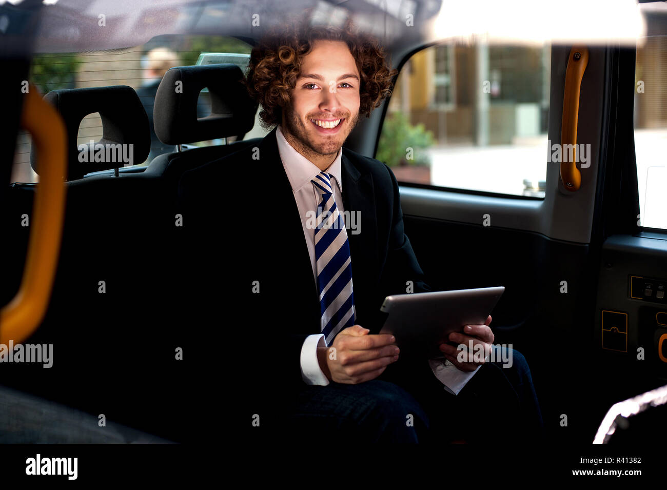 Smart young businessman inside taxi cab Stock Photo - Alamy