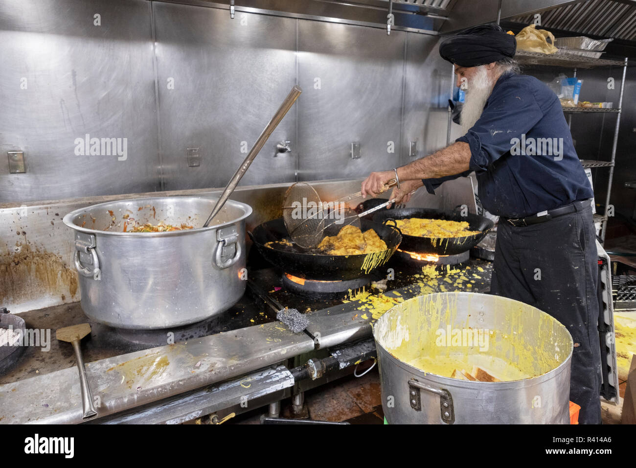 A Sikh man in a langar - communal kitchen - making bhature, Indian ...