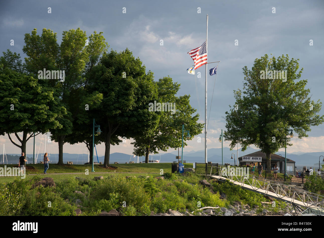 People walking along Waterfront Park in downtown Vermont on summer ...