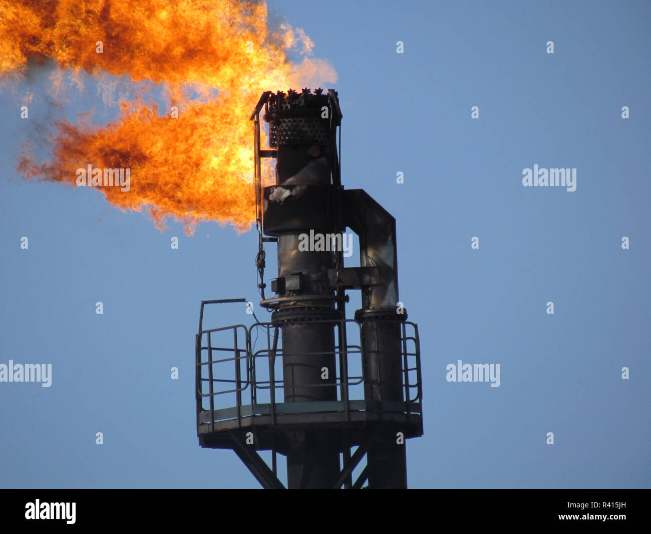 Torch system on an oil field Stock Photo - Alamy