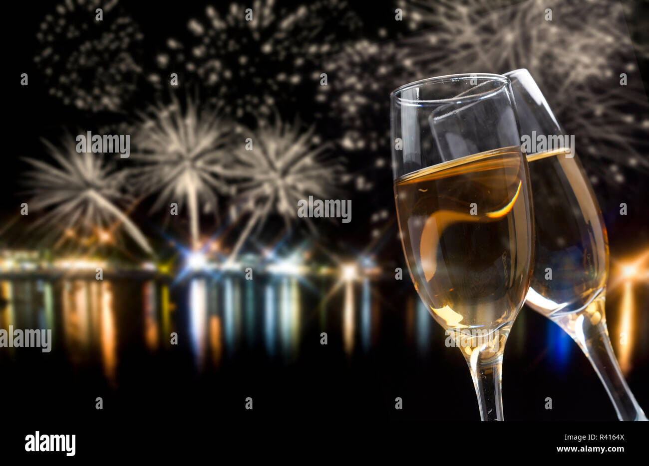 Celebrating New Year with champagne and fireworks Stock Photo - Alamy