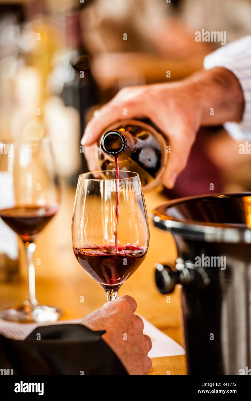 USA, Washington State, Vancouver. Man pouring red wine at Burnt Bridge ...