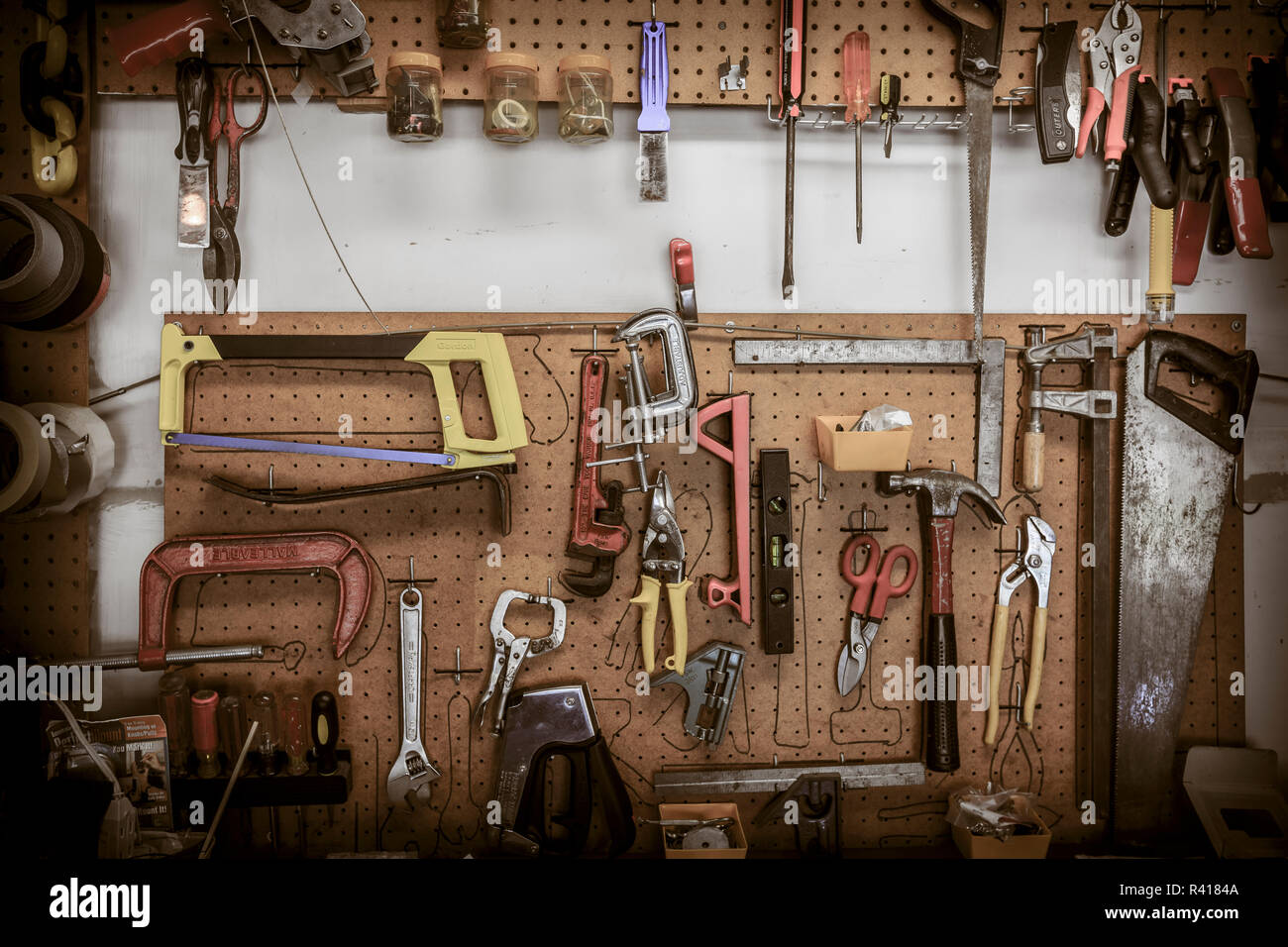 Tools hanging at a home workbench Stock Photo - Alamy
