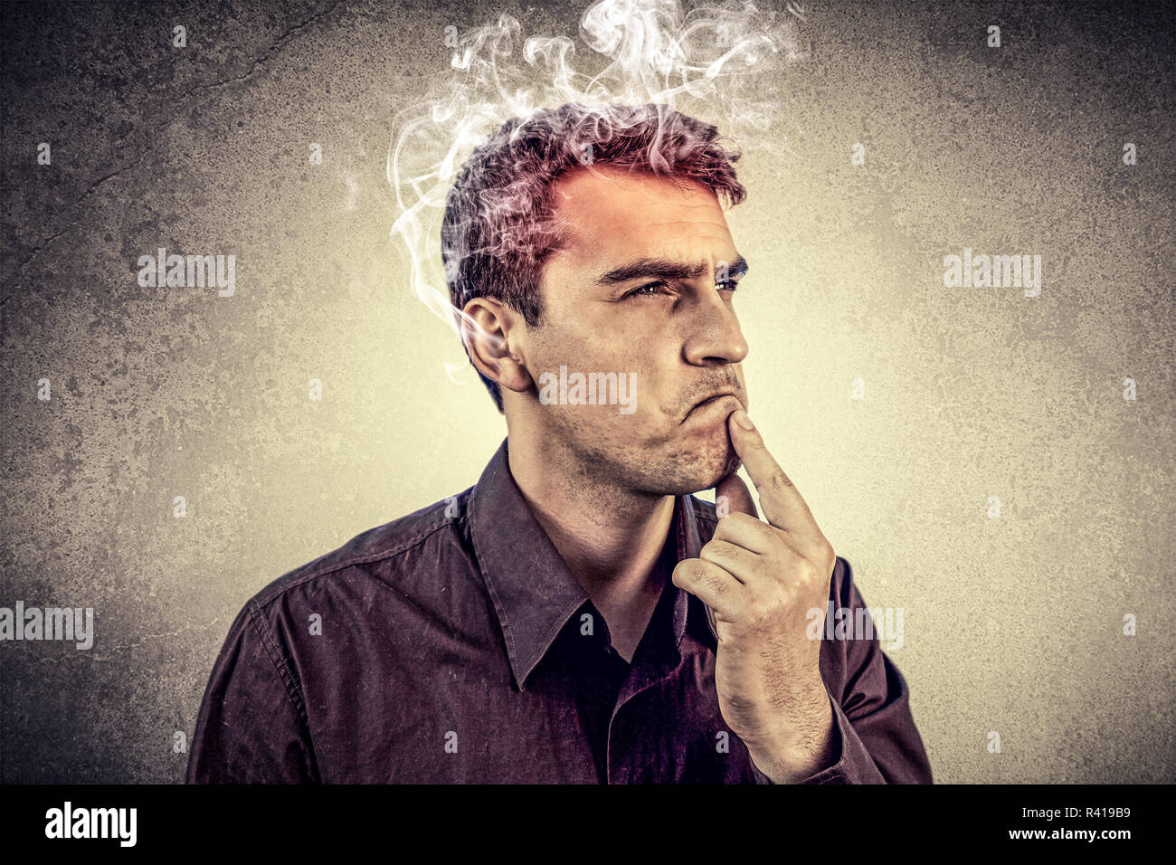 Portrait of Young man intensively thinking too hard with waving smoke ...