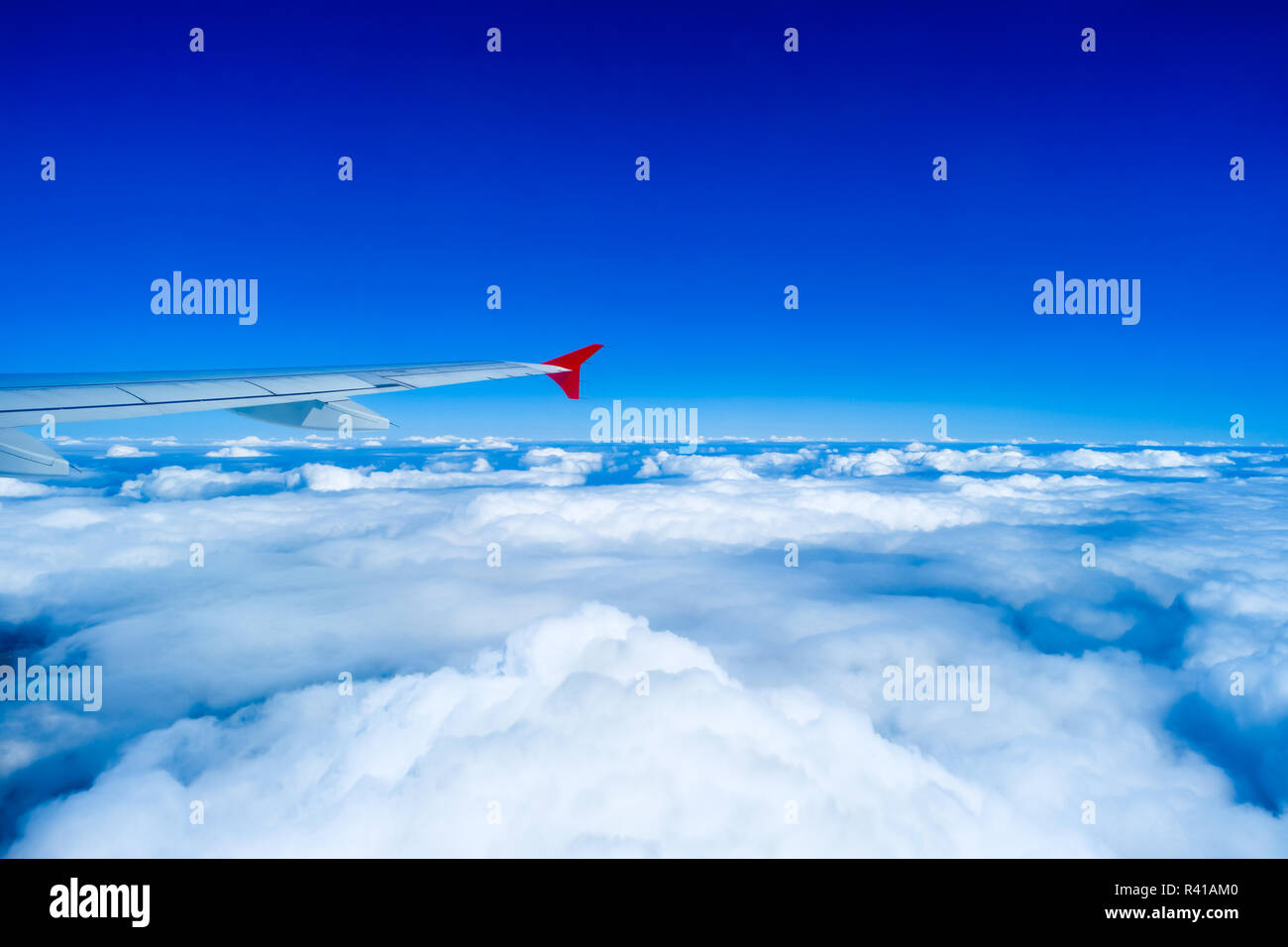 Airplane flying above clouds Stock Photo - Alamy