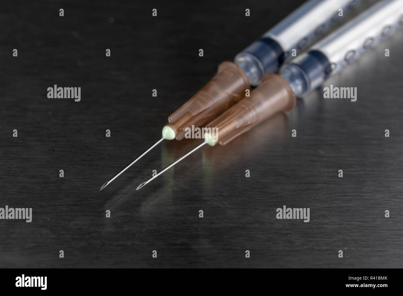 Medical syringes on a metal table. Medical accessories used for ...
