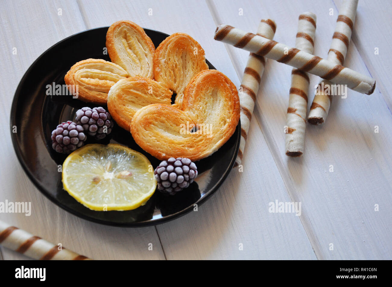 Pastry with bramble and a slice of lemon Stock Photo - Alamy