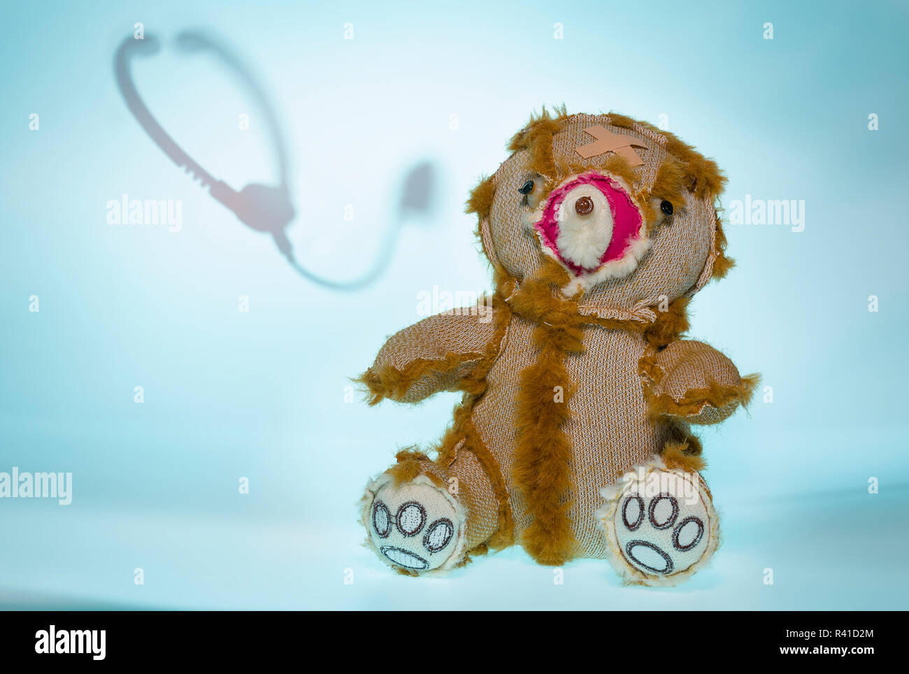 disheveled teddy bear with plaster and stethoscope Stock Photo - Alamy