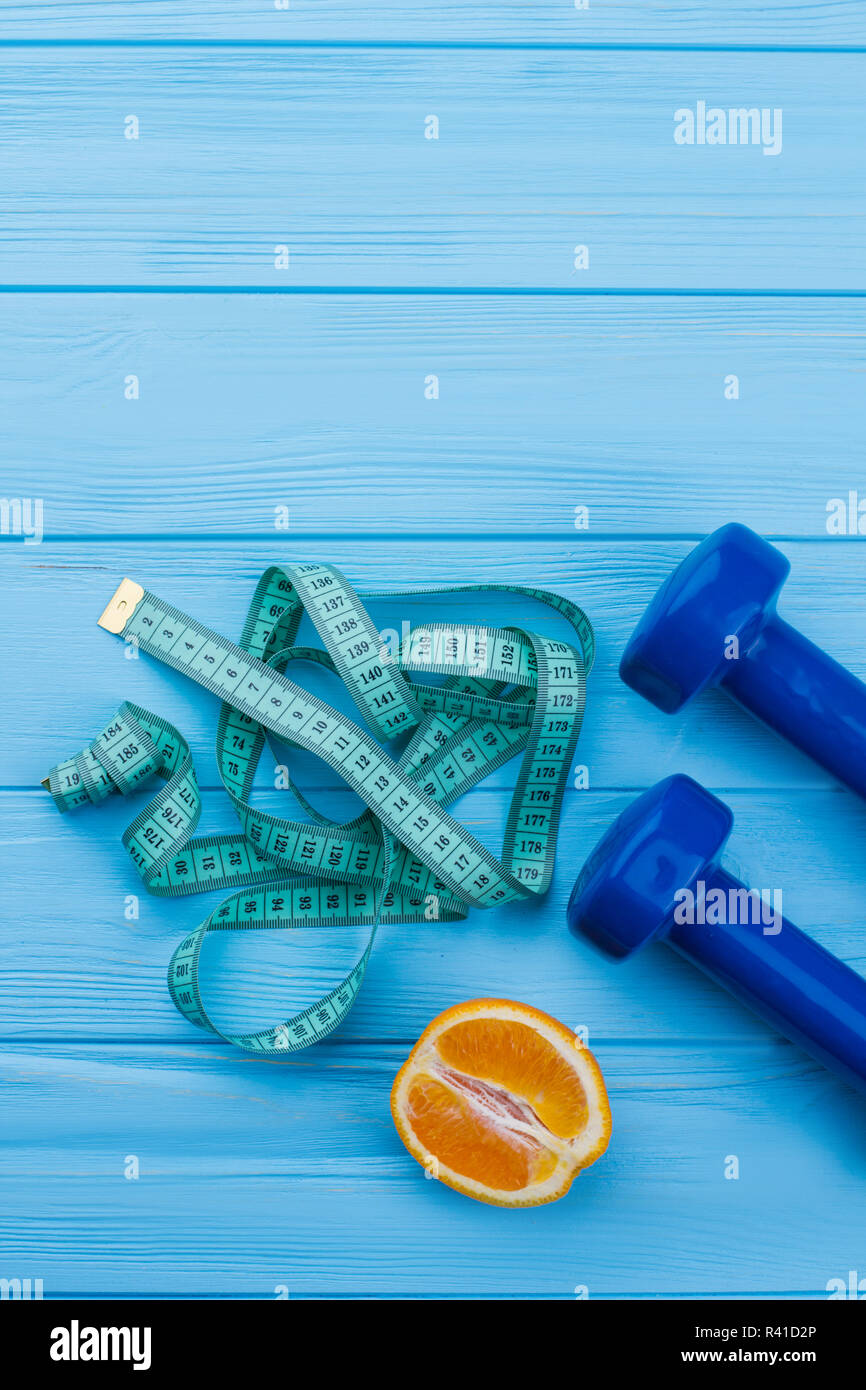 Healthy lifestyle and slimming concept. Measuring tape, dumbbells and ...