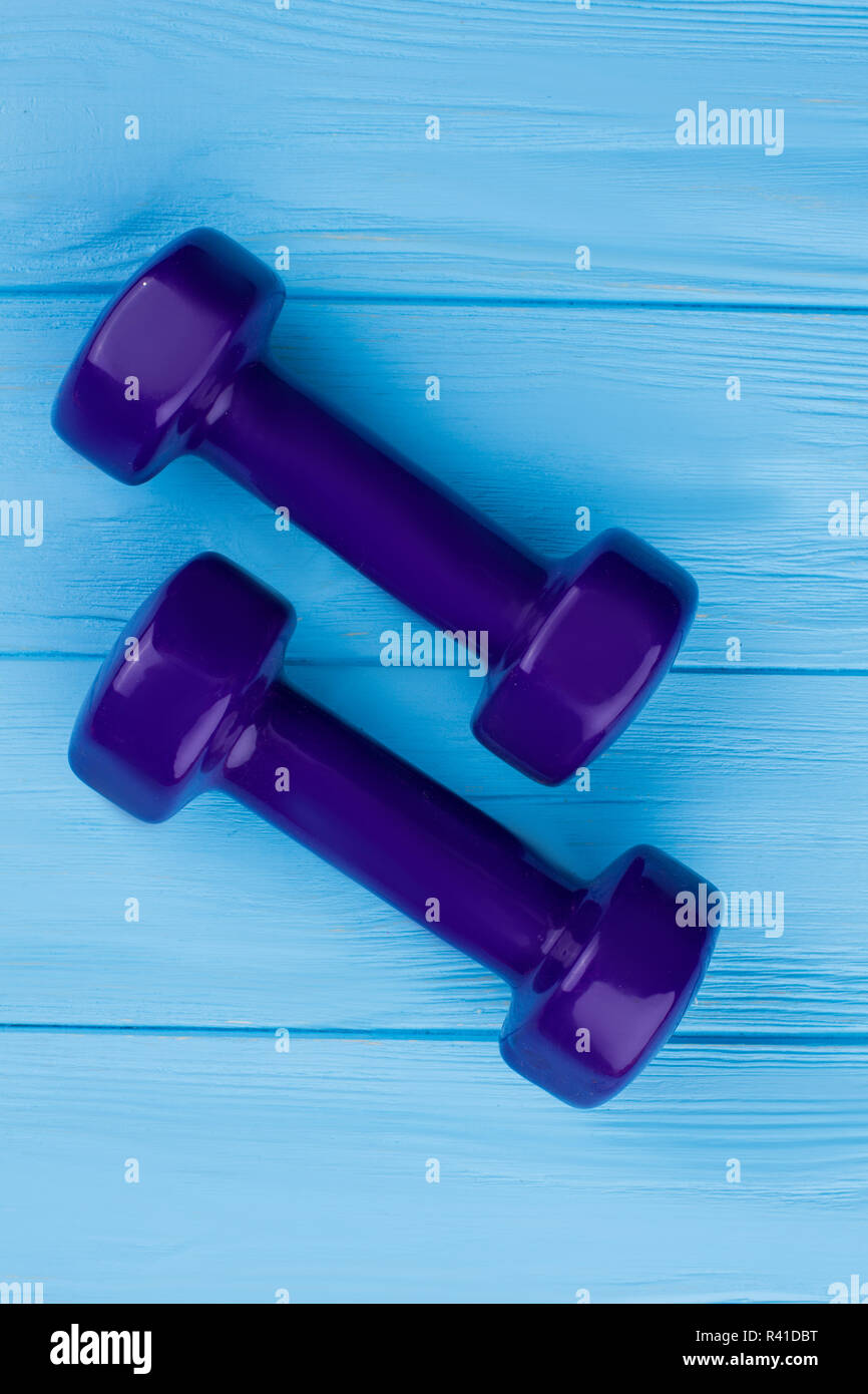Pair of dumbbells, top view. Hand weights on wooden background ...