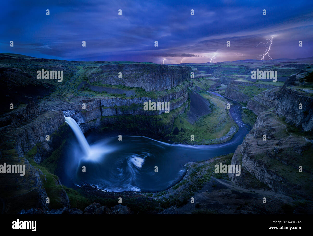 USA, Washington State. Palouse Falls at dusk with an approaching ...