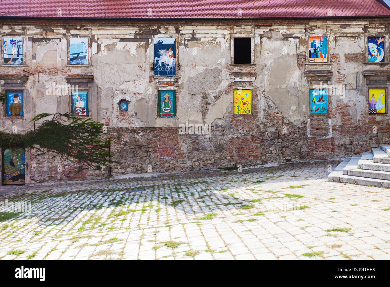 neglected house with mural paintings in windows Stock Photo - Alamy