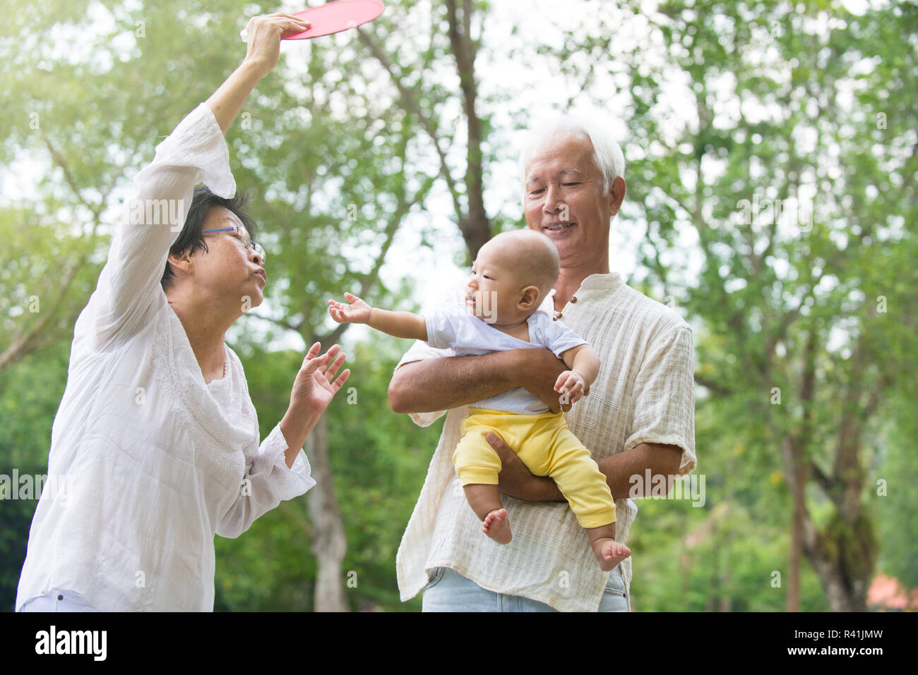 Chinese grandfather grandmother playing baby hi-res stock photography ...