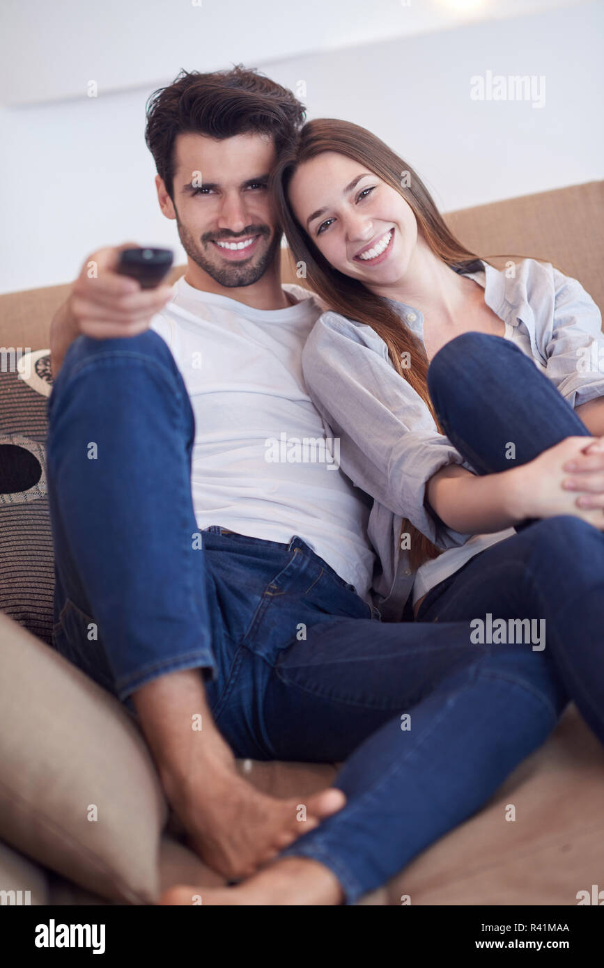 young couple watching tv at home Stock Photo - Alamy