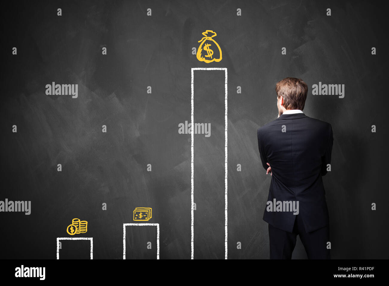 businessman standing in front of a blackboard with a chart about ...