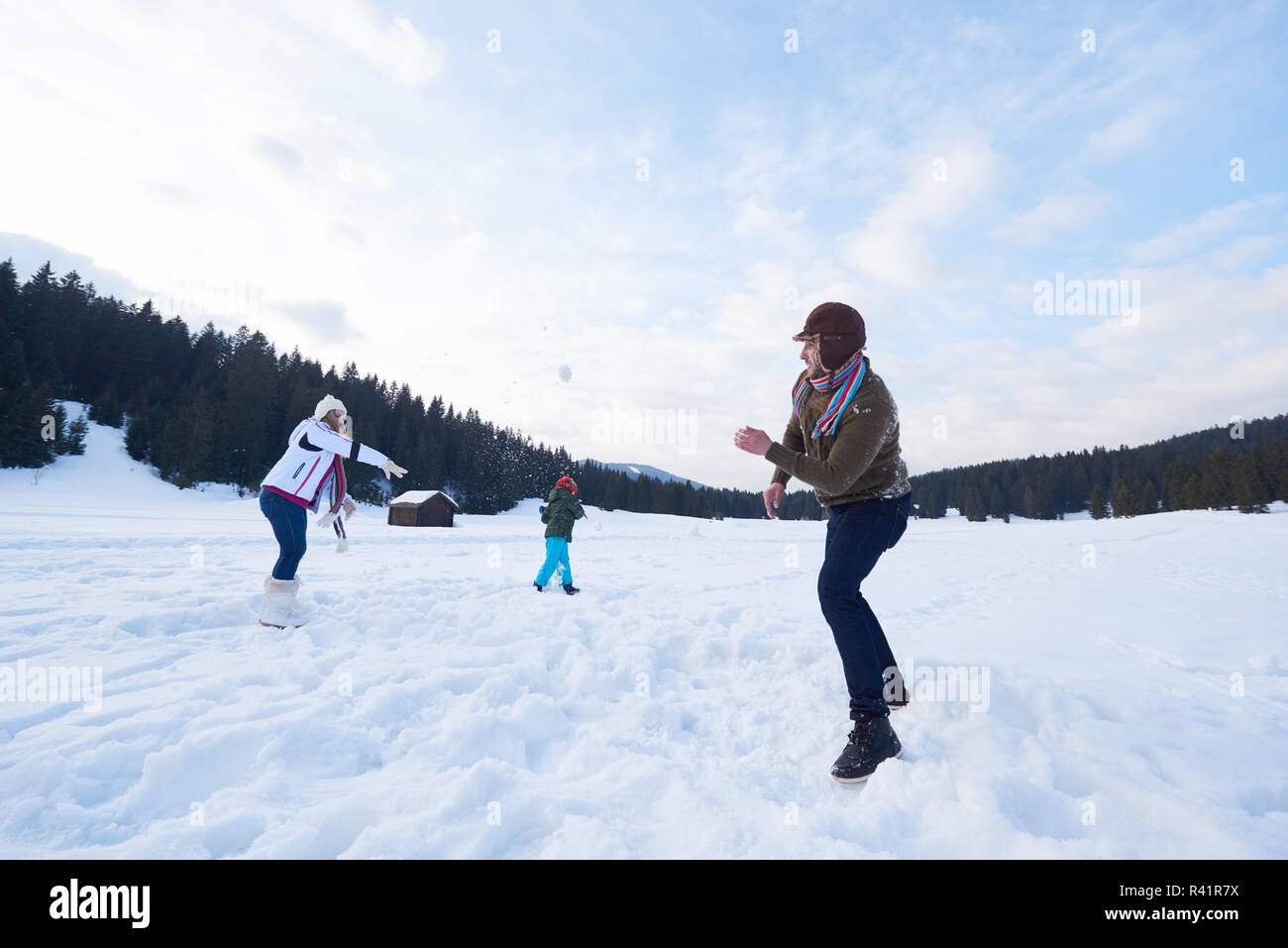 happy family playing together in snow at winter Stock Photo - Alamy