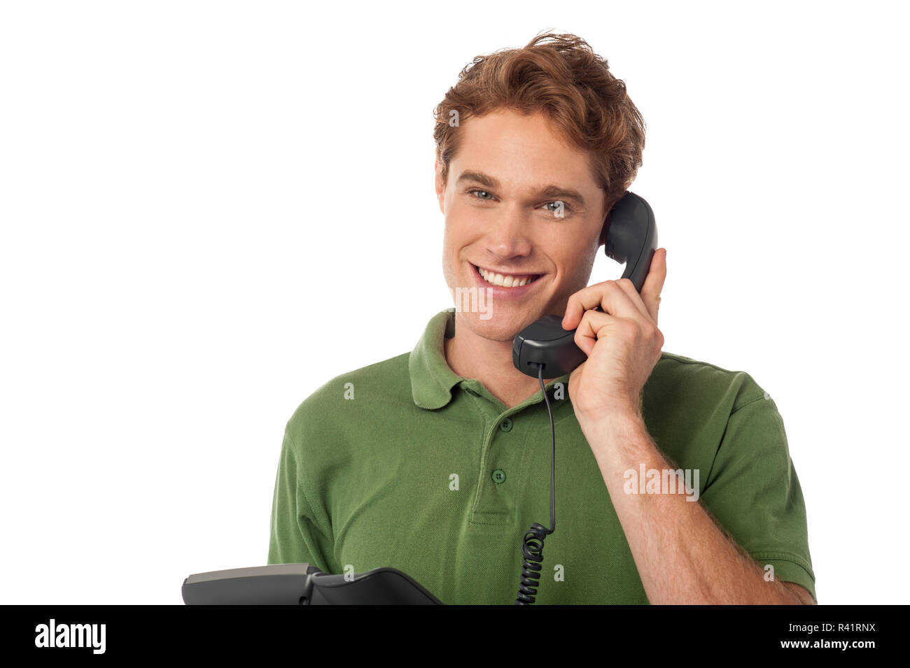 Young man holding a receiver and talking Stock Photo - Alamy