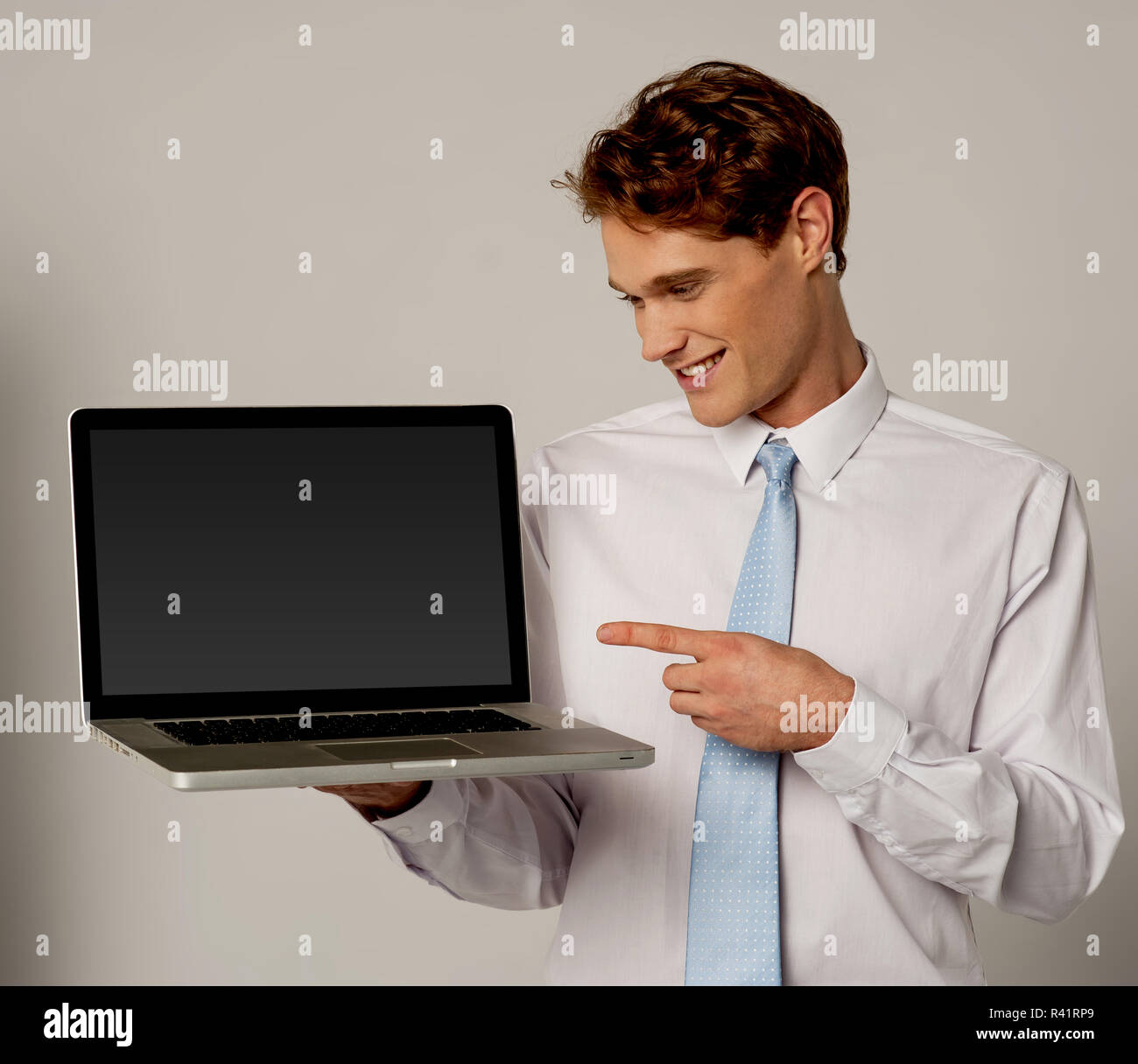 Smart executive showing new laptop Stock Photo - Alamy