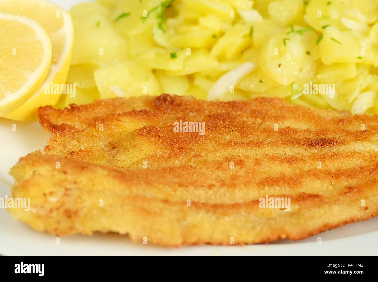 plaice fillet breaded with potato salad Stock Photo - Alamy