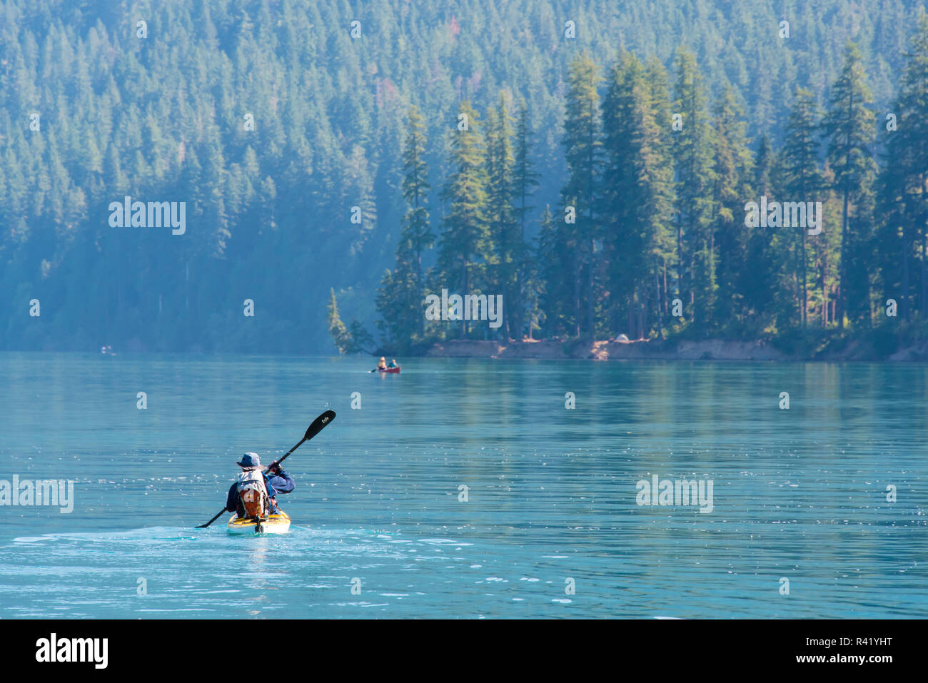 USA, Washington State. Kayaker on Baker Lake. Anderson Point Campground ...