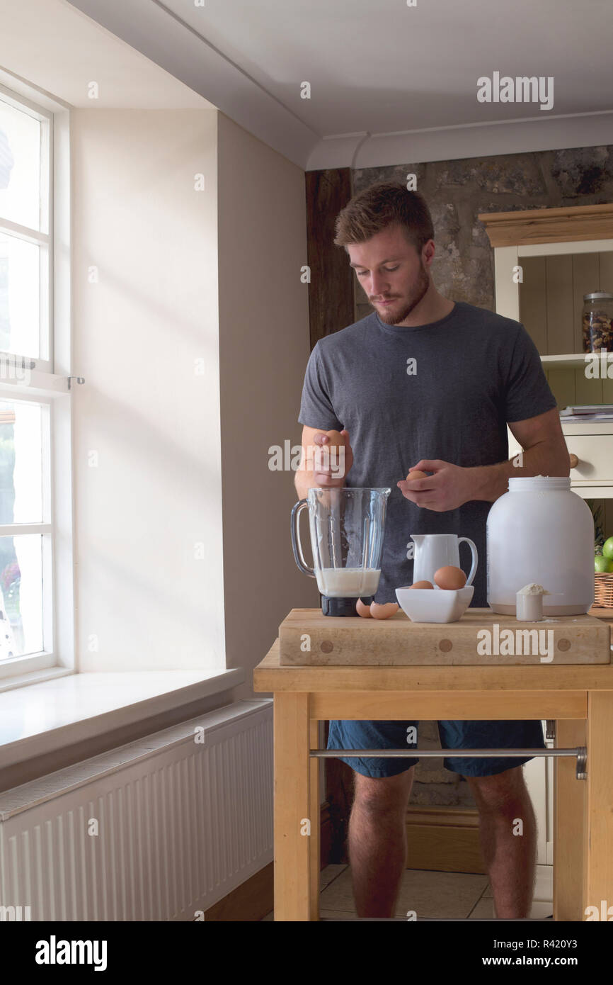 Young man making a protein shake Stock Photo - Alamy