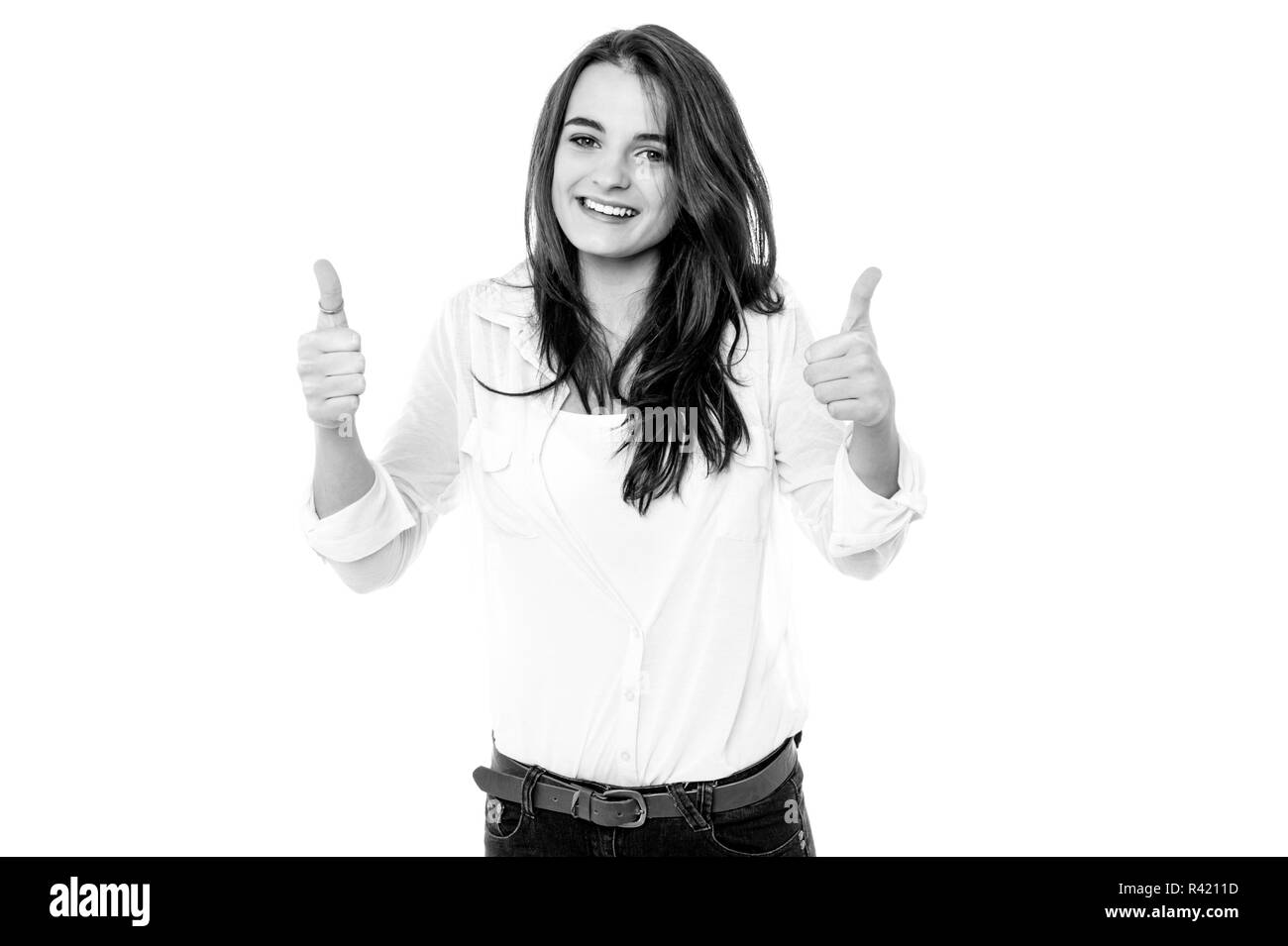 Pretty girl showing double thumbs up Stock Photo - Alamy