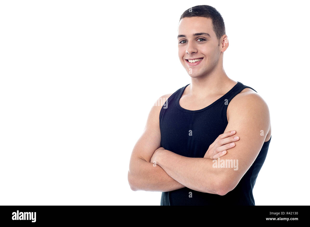 Young fit smiling guy posing confidently Stock Photo - Alamy