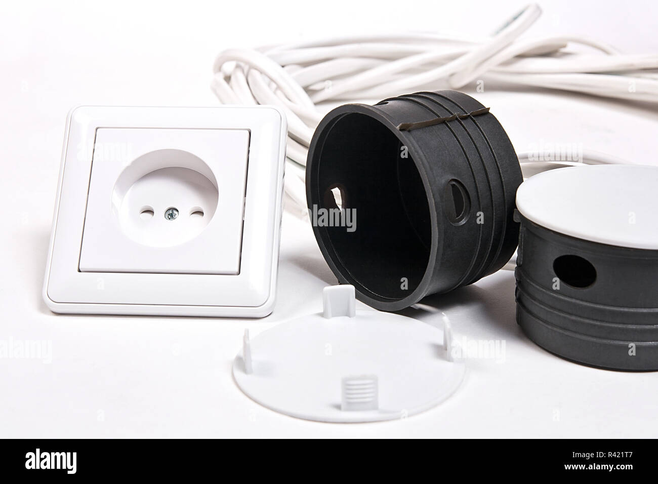 Electric sockets and power cable on white surface Stock Photo - Alamy