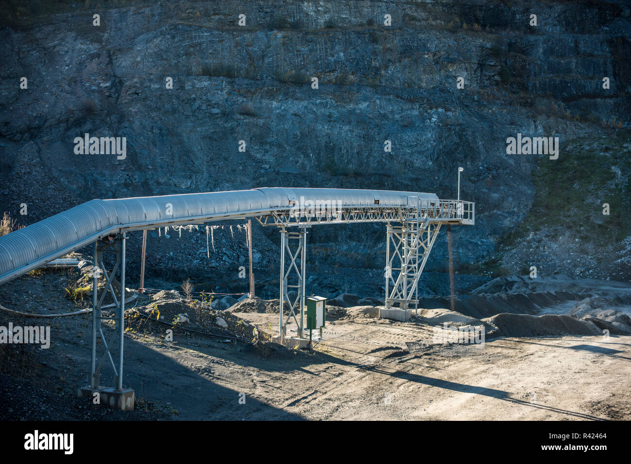 a clad with aluminum conveyor belt transports in a quarry loose ...