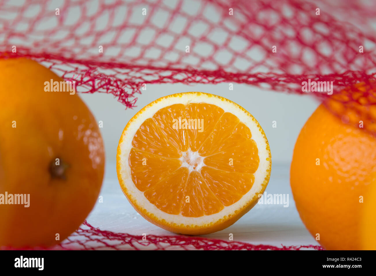 oranges on the net Stock Photo - Alamy