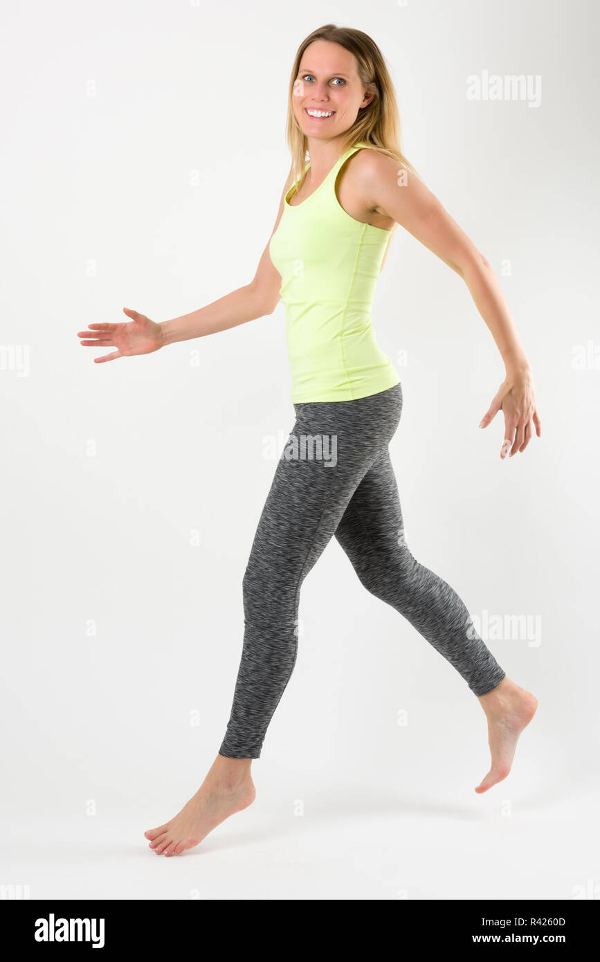 Blond athletic woman running elegant Stock Photo - Alamy