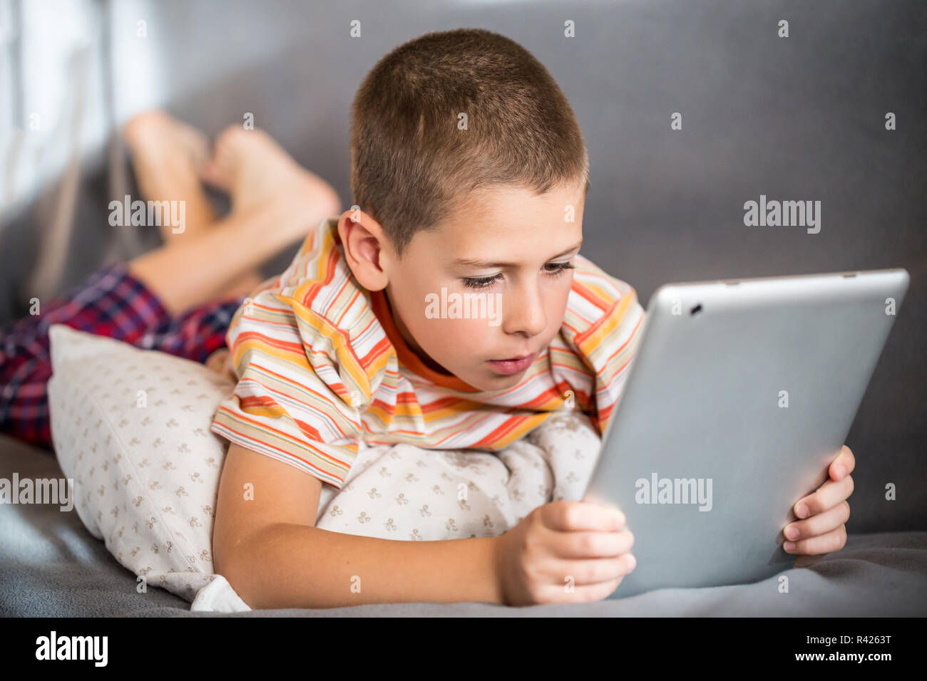 Boy using tablet Stock Photo - Alamy