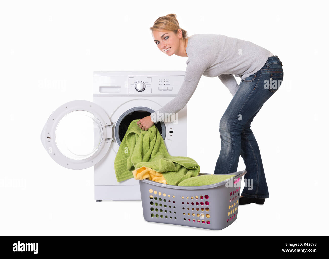Woman Loading Washing Machine Stock Photo - Alamy
