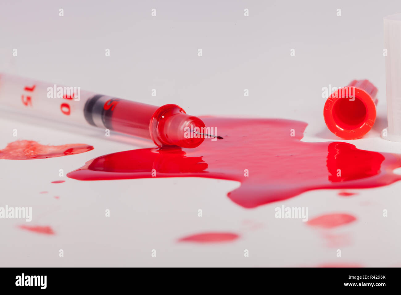 syringe with hypodermic needle and blood stain Stock Photo - Alamy
